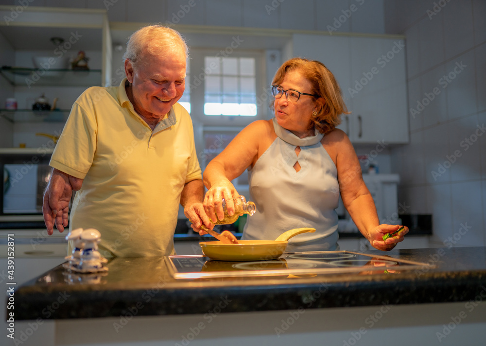 Latin man with amputated arm cooking with his wife. Overcoming the ...