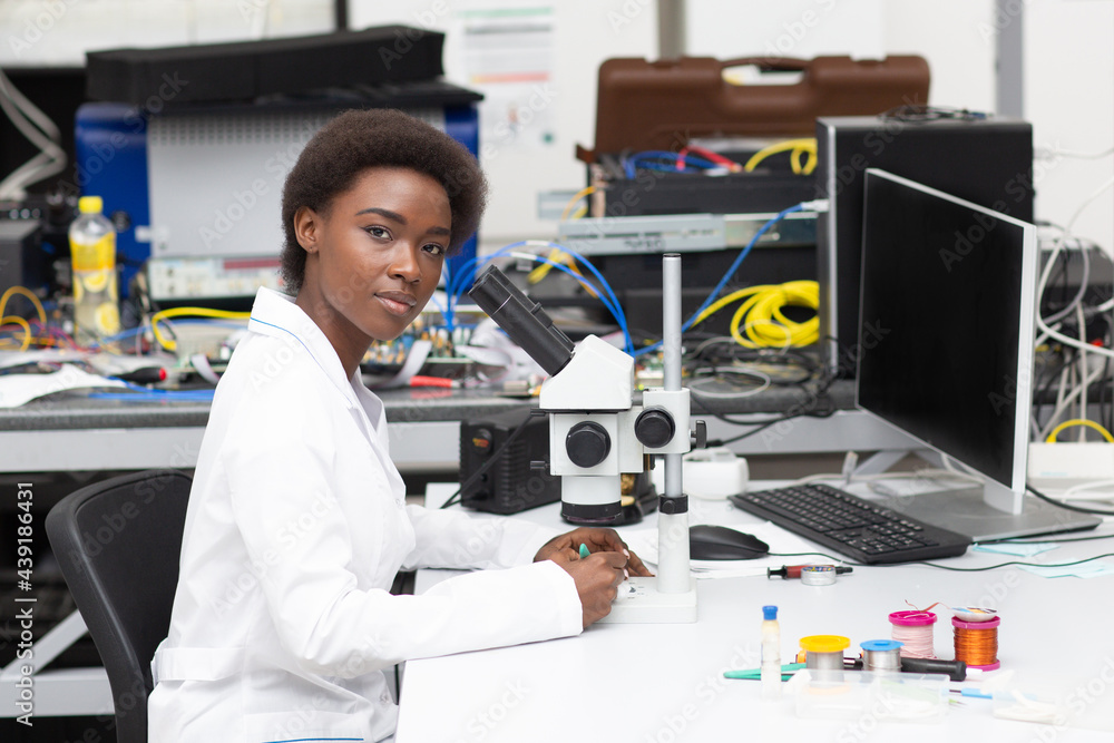 Scientist african american woman working in laboratory with tech ...