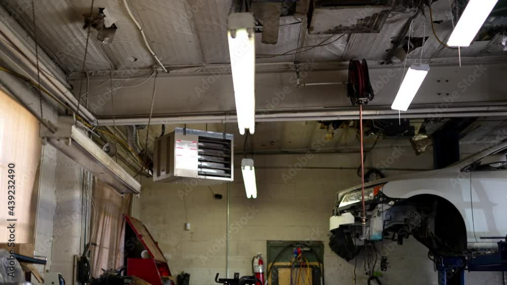 Mechanics home garage shop with cars on lift and tools and equipment ...