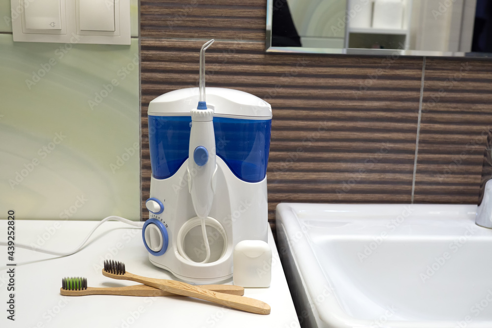 Tools for cleaning teeth in the bathroom. Irrigator and dental floss ...