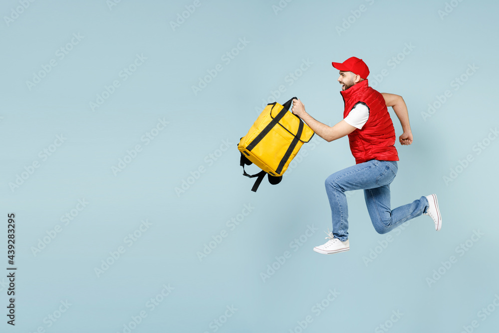 Full size body length side view delivery guy employee man in red cap ...