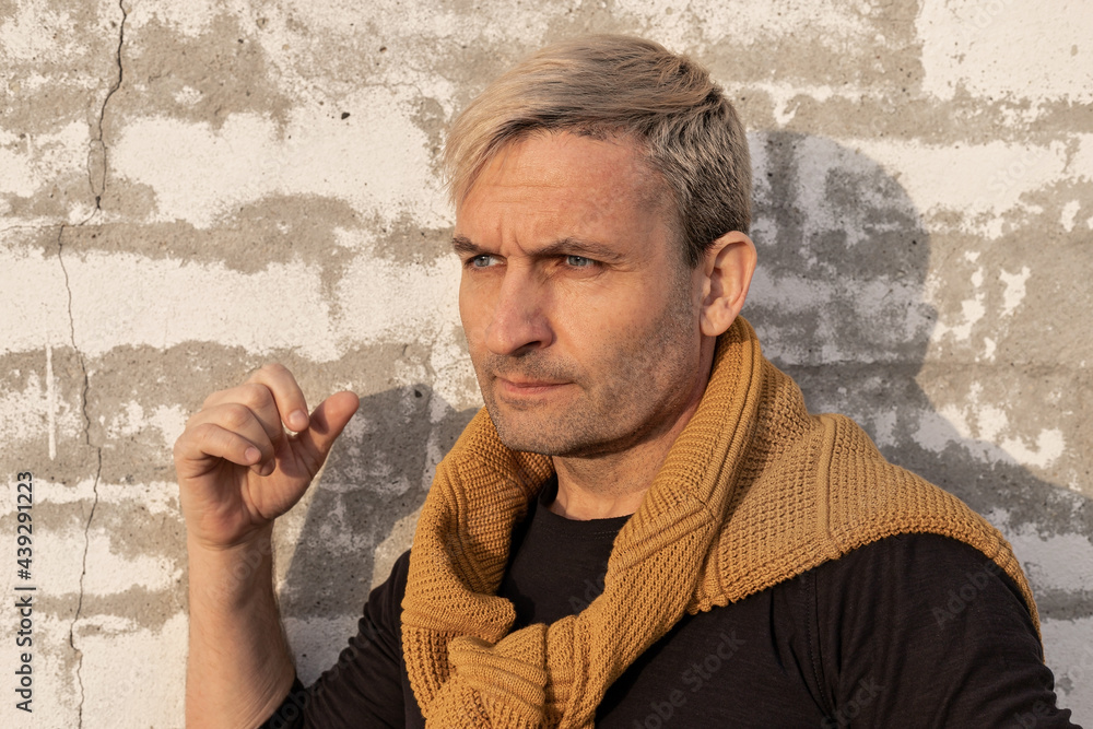 Pensive stylish charming blond middle-aged man of model appearance in ...