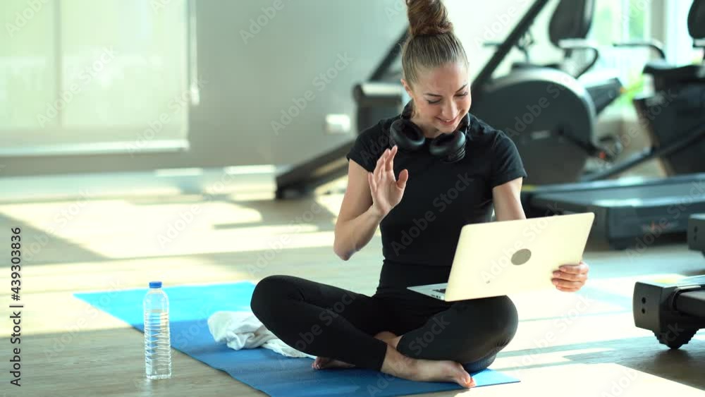 young fit woman in sportswear take a break after exercises on yoga mat ...