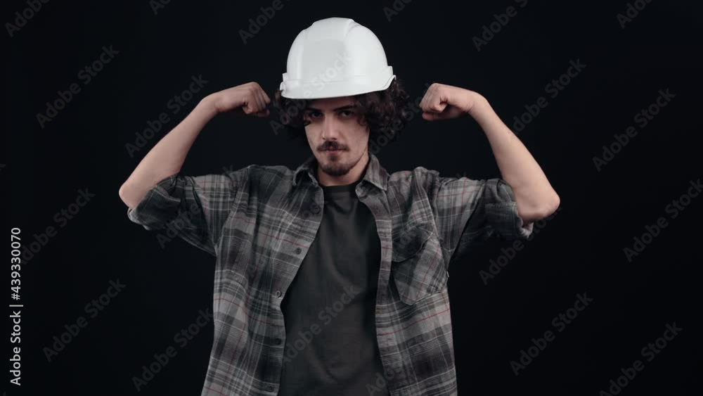 The hipster boy, with a white engineer's helmet, strong and confident ...