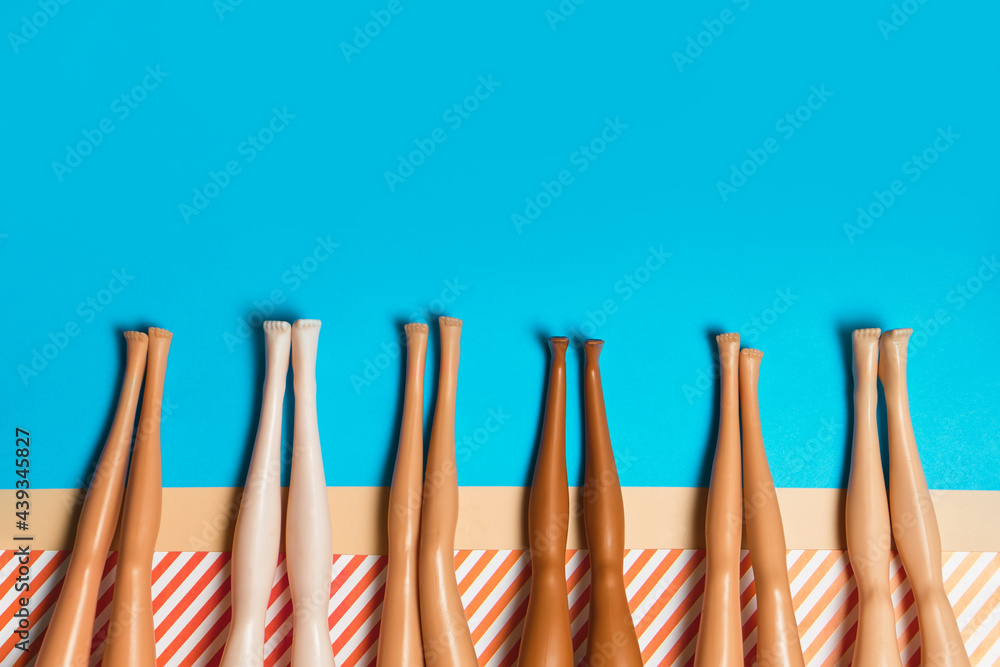 doll legs different colors of skin on blue background Stock Photo ...