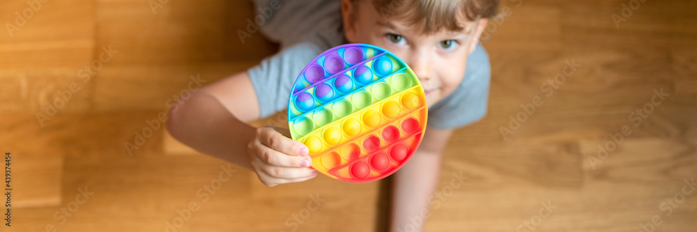 anti stress sensory pop it toys in a children's hands. a little happy ...