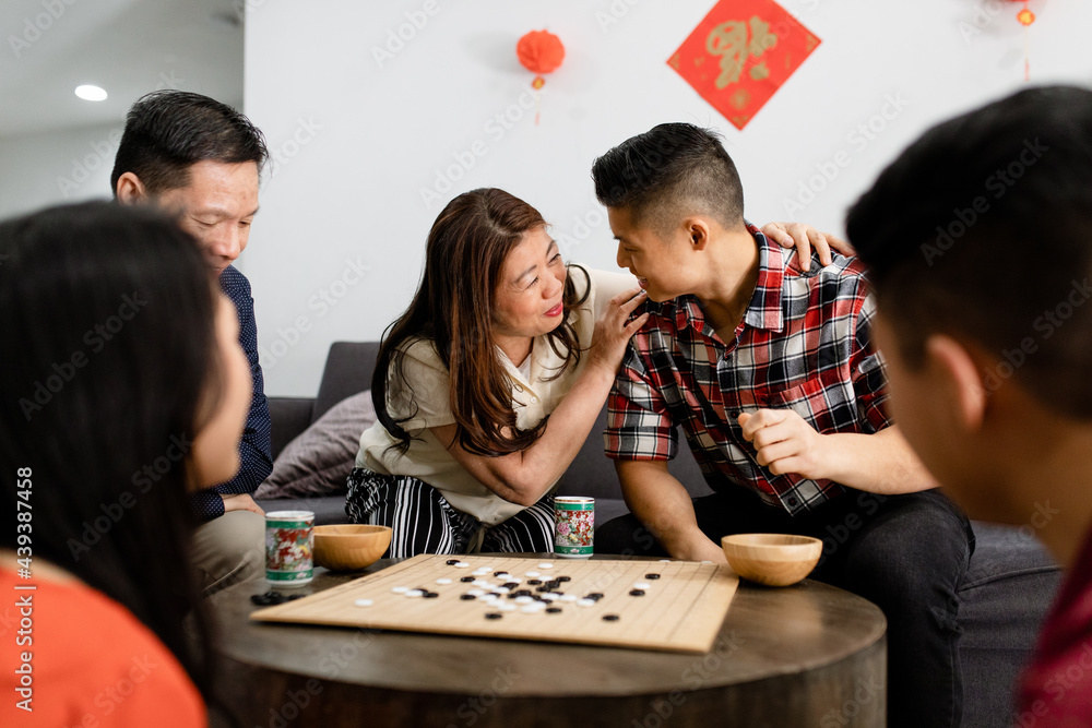 Chinese Family Playing Board Game During Chinese New Year Stock Photo ...