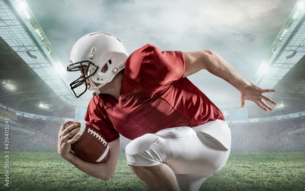 American football sportsman player with ball in action on stadium under ...