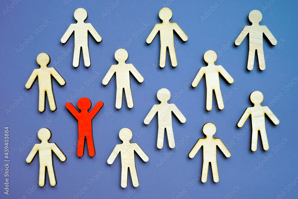 Be different concept. One unique figurine in the crowd as symbol of ...