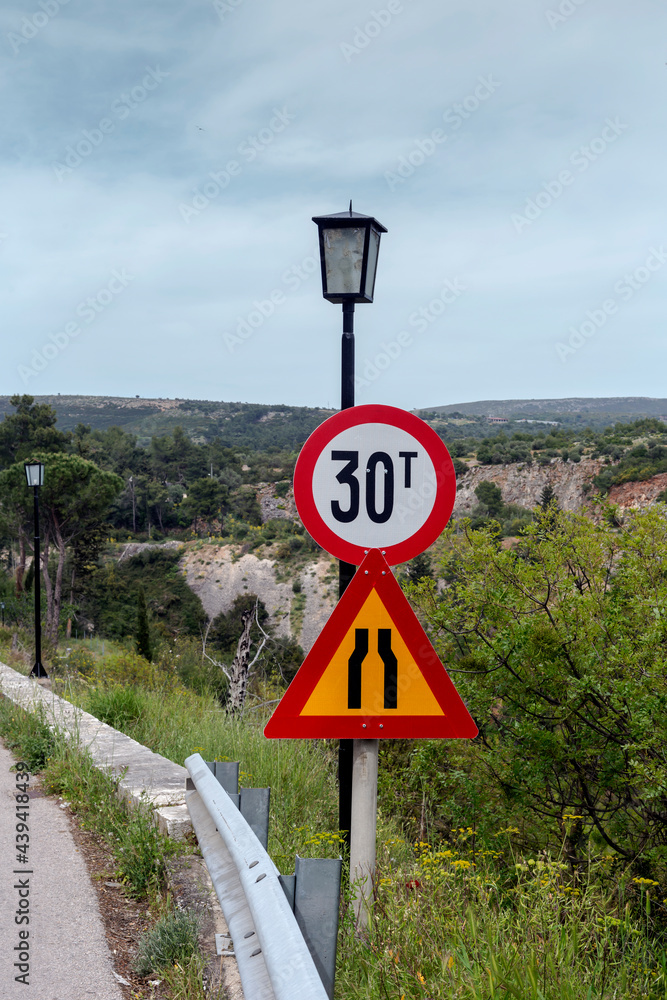Sign "Narrowing the road on both sides" and the sign "Speed limit ...