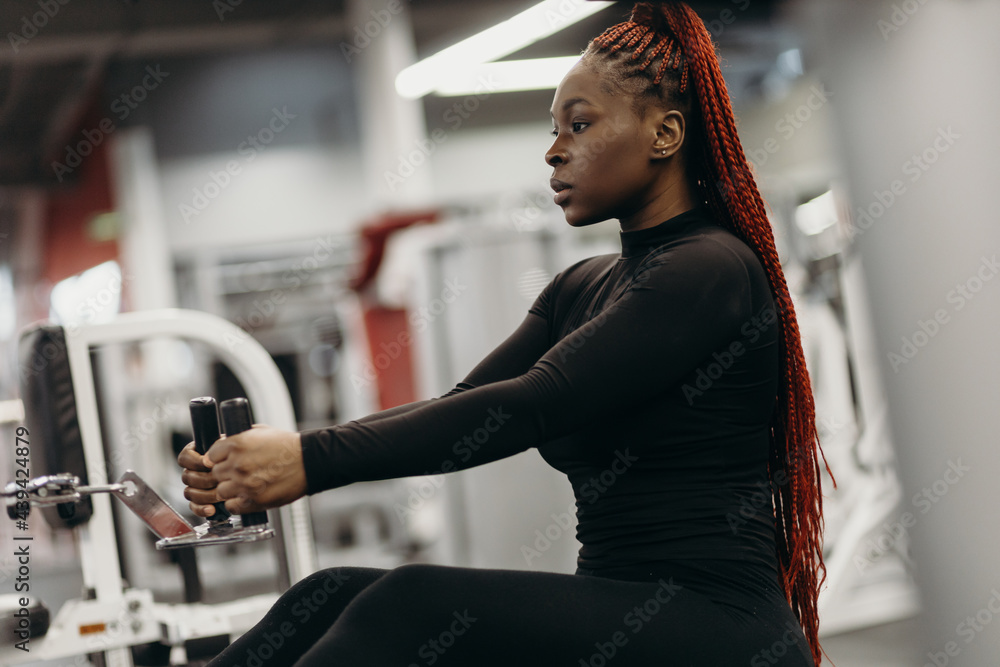Black female athlete ding exercises on rowing machine Stock Photo ...