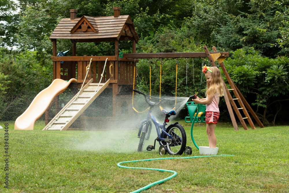 Young girl Washing her bicycle in the backyard of home Stock Photo ...