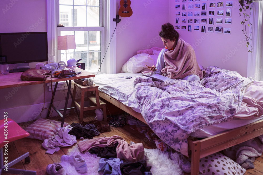 college student studying in messy room Stock Photo | Adobe Stock