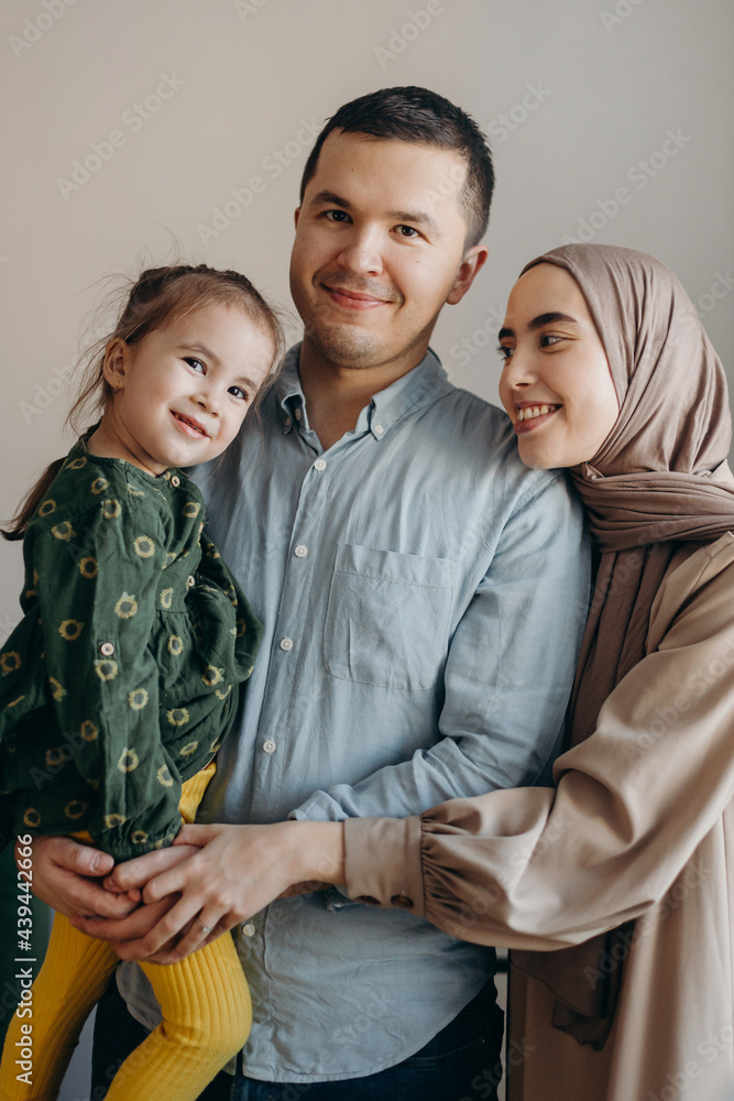 Cheerful Islamic family hugging and smiling at camera Stock Photo ...