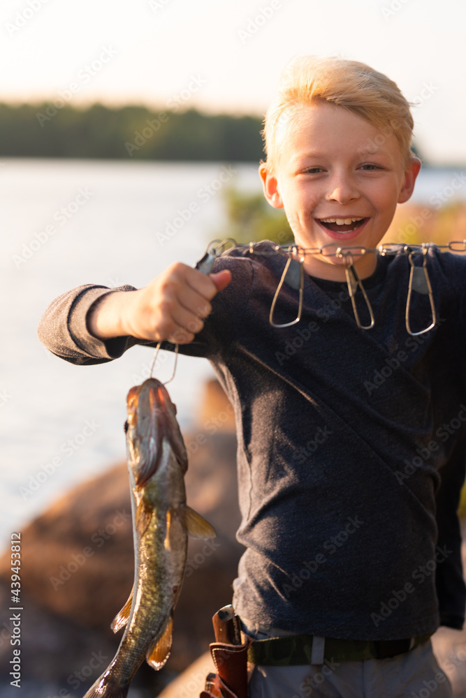Boy proudly shows off fish caught on Muskoka fishing vacation Stock ...