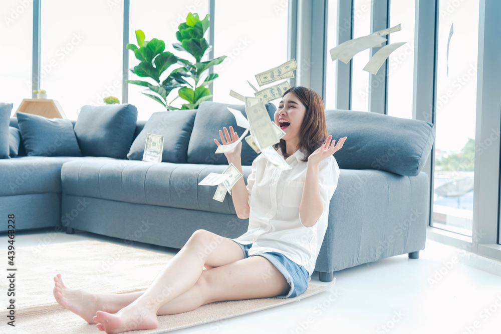 Happy young asian woman holding dollar money and throw in the air ...
