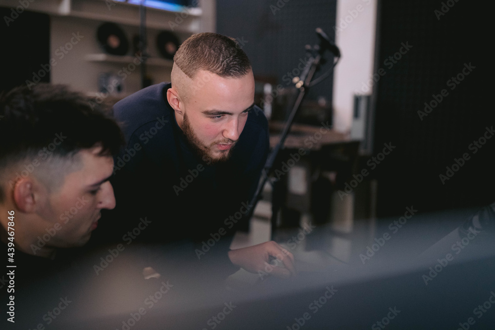 Boys writing and creating music together in recording studio Stock ...