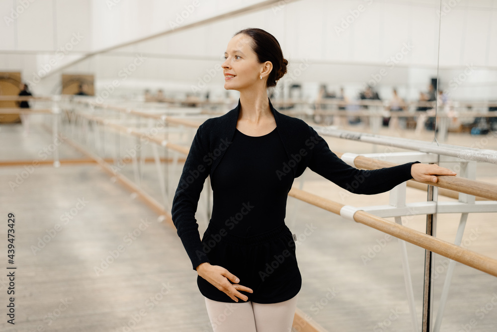 Graceful woman practicing ballet position at the barre Stock Photo ...