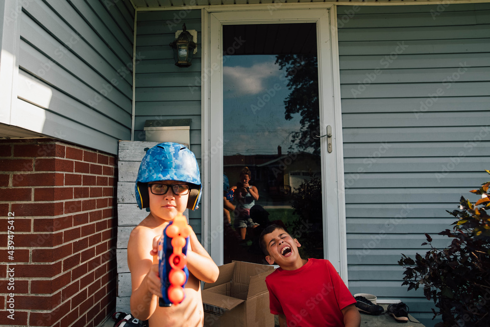 Young brother is protecting older brother who is crying on front porch ...