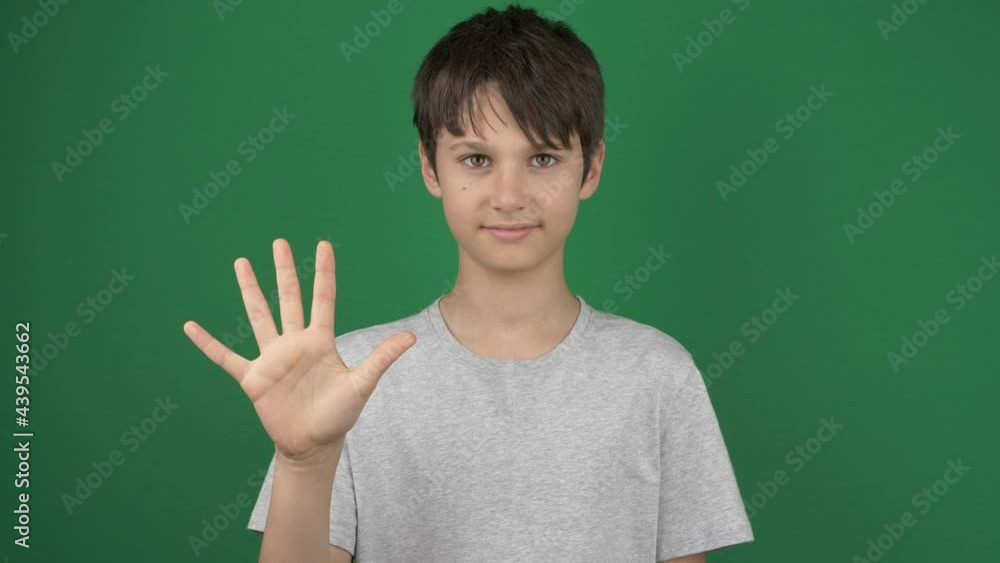 Teenage boy showing numbers with fingers from 1 to 5, counting one, two ...
