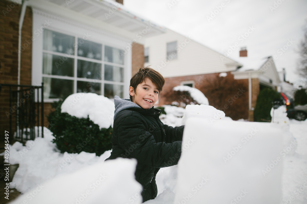 boy hides behind snow fort for snowball fight Stock Photo | Adobe Stock