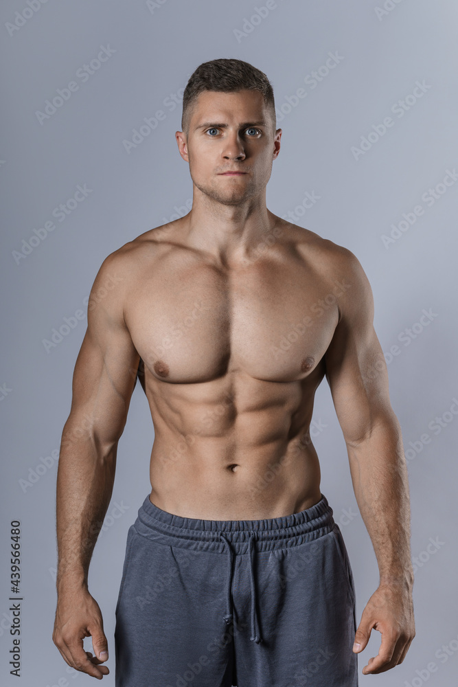 Bodybuilder showing his muscular body against gray background Stock ...