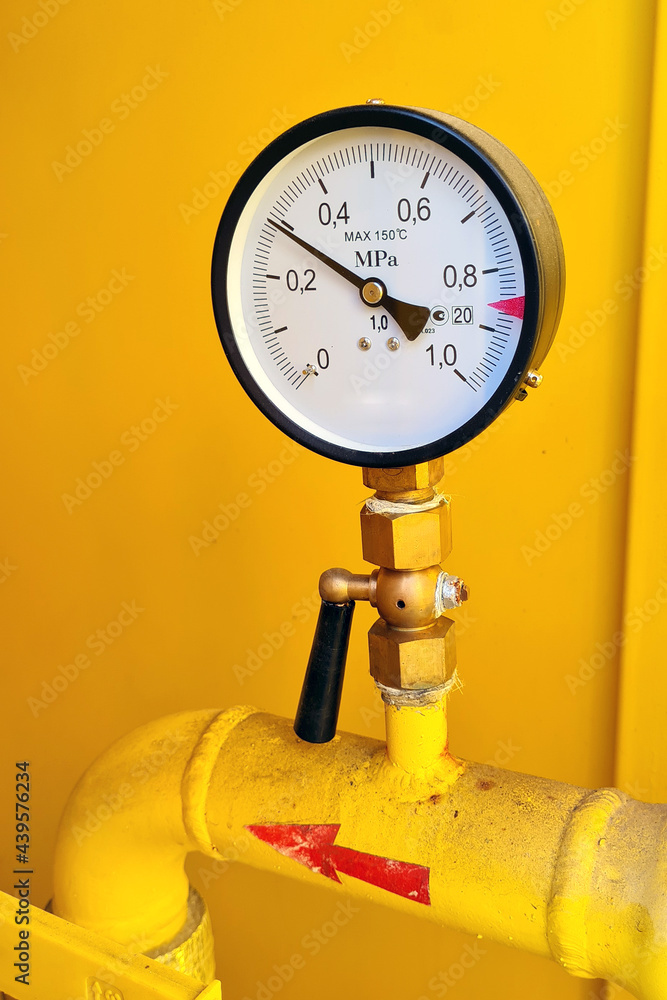 High pressure gauge meter or manometer installed to gas tube in yellow ...