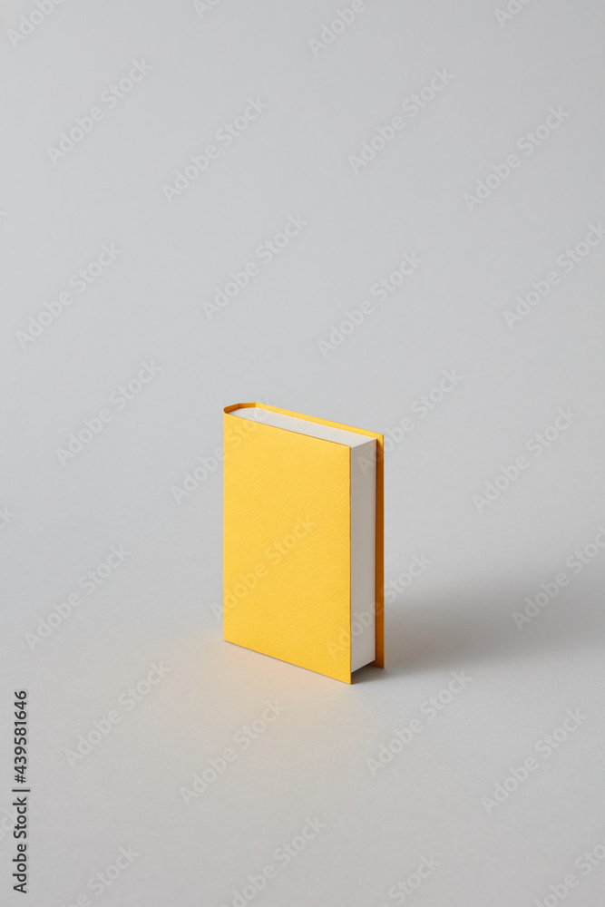 Yellow papercraft book on gray background Stock Photo | Adobe Stock