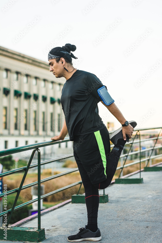 Man stretching his leg muscles Stock Photo | Adobe Stock