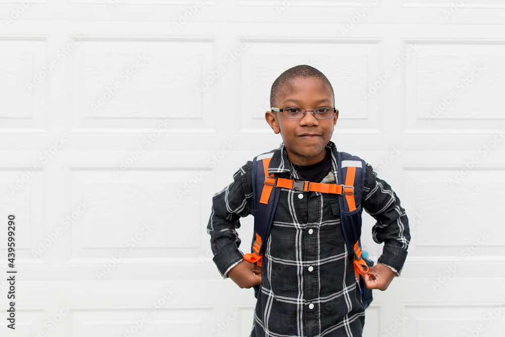 Smiling boy in backpack on first day of school Stock Photo | Adobe Stock