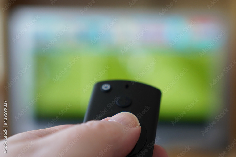 hand pointing remote control at tv with soccer or football match Stock ...