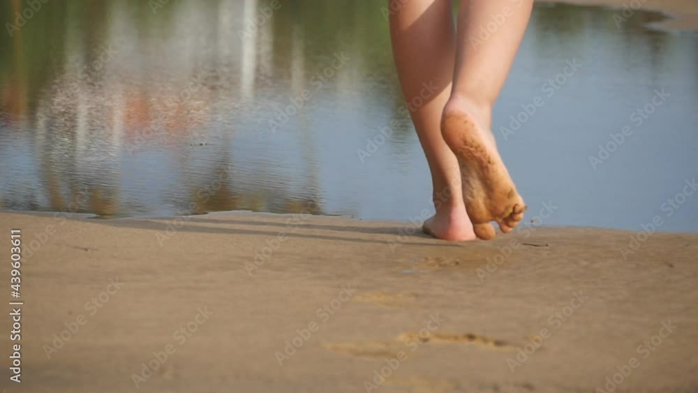 Low view of female legs steps into big puddle of ocean water near ...