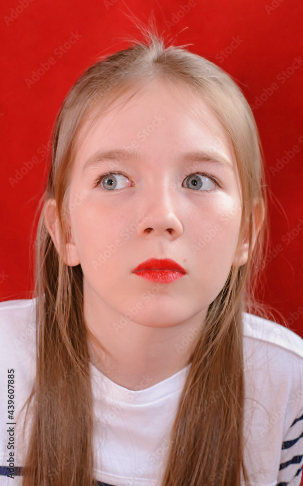 Young teen girl with red lips with surprised, nervous, worried or ...