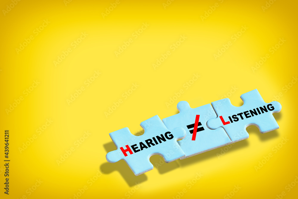 Hearing is not same as listening written on blue puzzle isolated on ...
