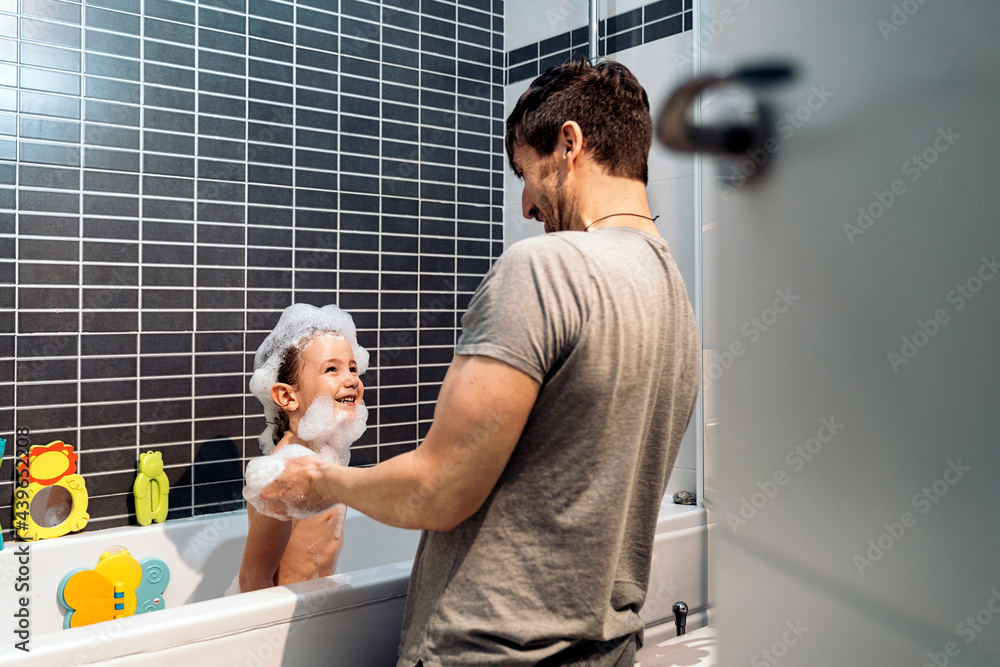 Father bathing his son. Stock Photo | Adobe Stock