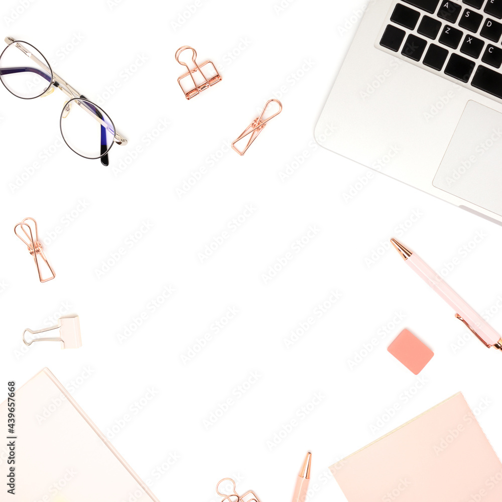 Frame made of laptop and pink office supply on a white background ...