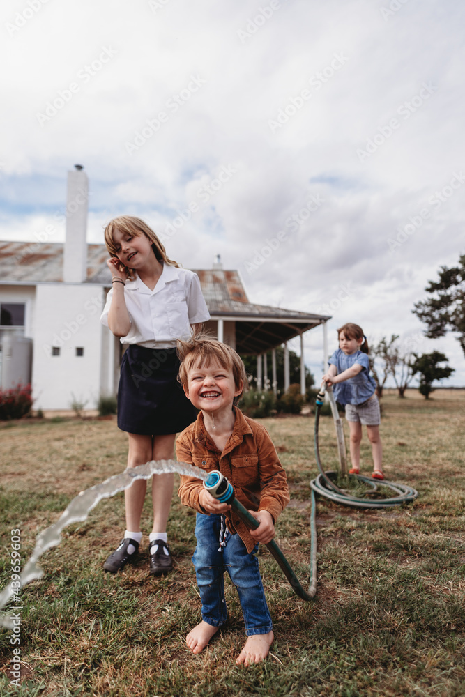 kids playing with hose Stock Photo | Adobe Stock
