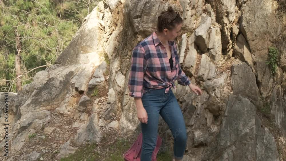 Haggard Girl Approaches Rock. Throws Backpack to the Ground. Leans Back ...