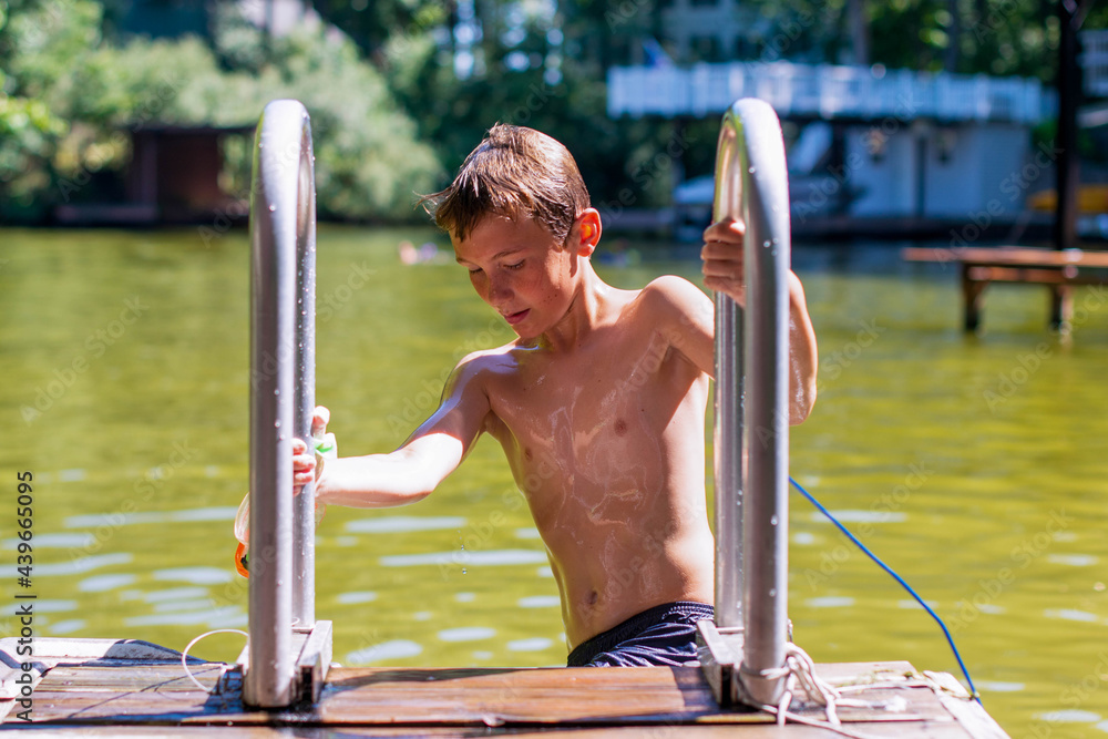 Teen Boy Swimming at Lake Stock Photo | Adobe Stock