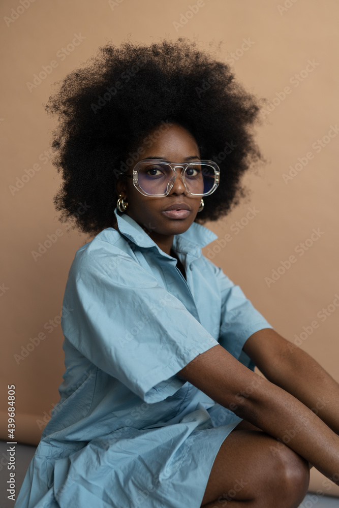 Black woman in blue dress and glasses Stock Photo | Adobe Stock