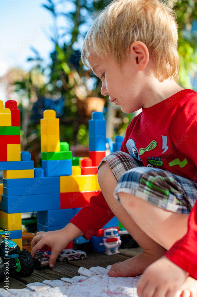 Little Boy Playing with Giant Bricks-like Blocks Stock Photo | Adobe Stock