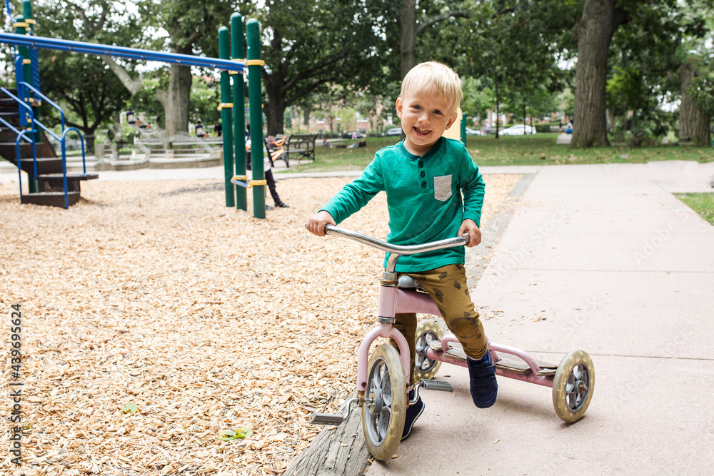 Little boy riding a tricycle Stock Photo | Adobe Stock
