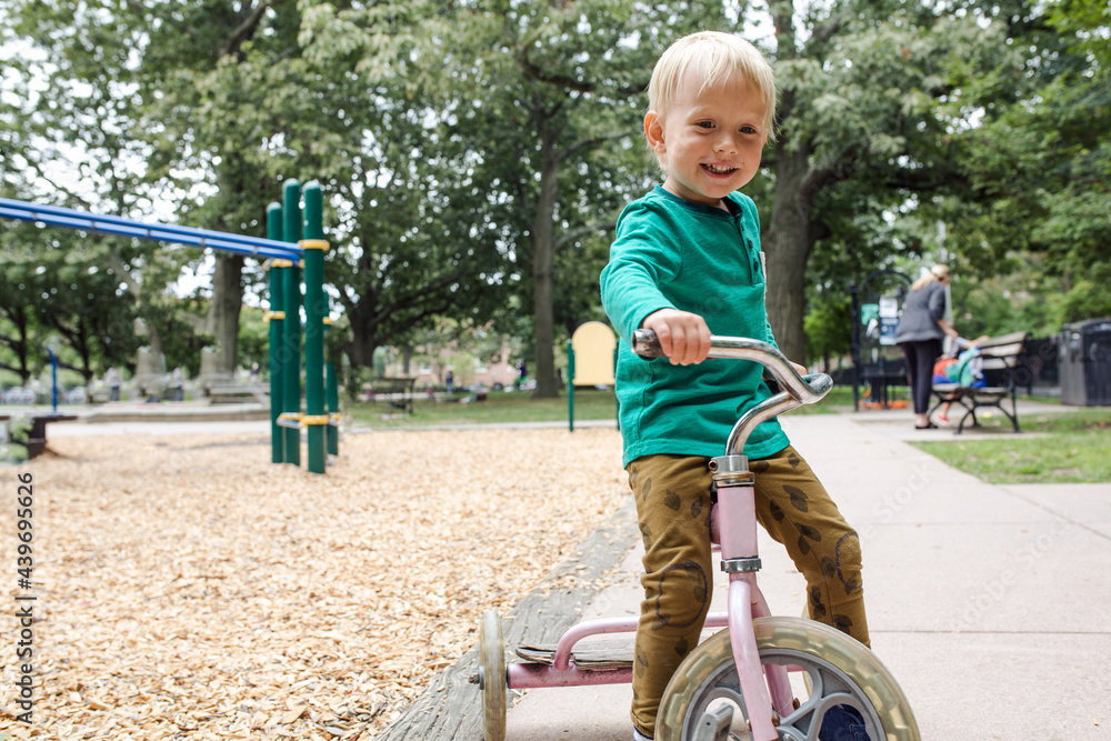 Little boy riding a tricycle Stock Photo | Adobe Stock
