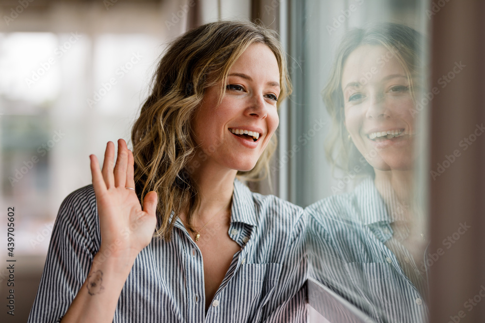 Beautiful Woman Smiles and Waves out of Her Apartment Window Stock ...