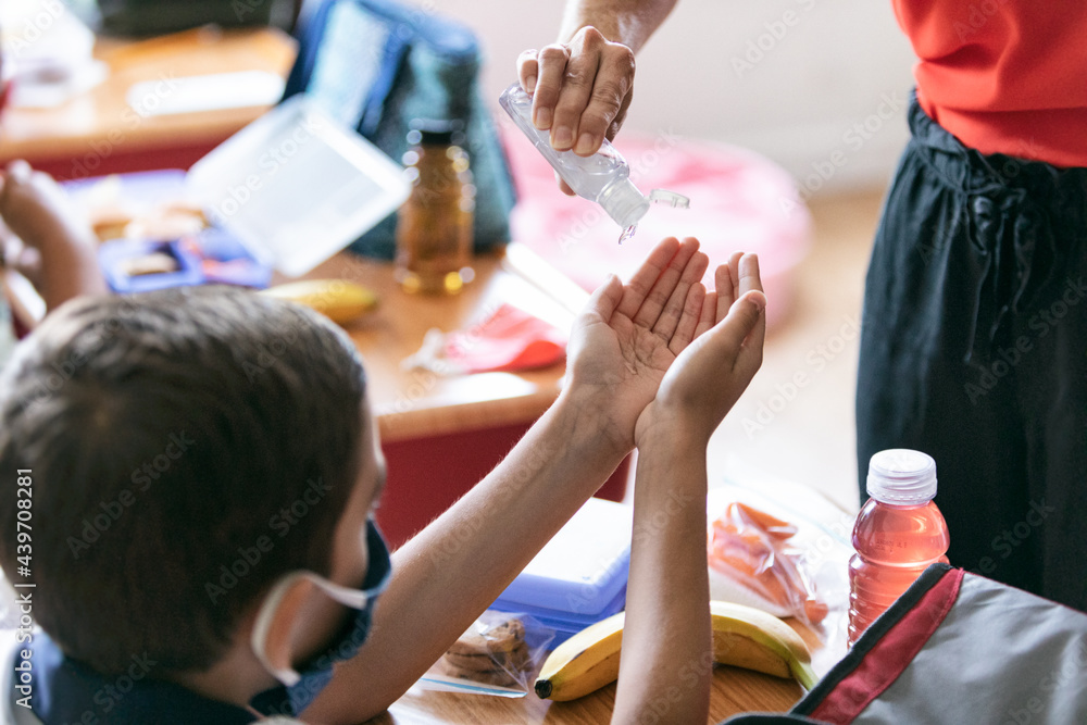 School: Teacher Gives Hand Sanitizer To Students Before Lunch Stock ...