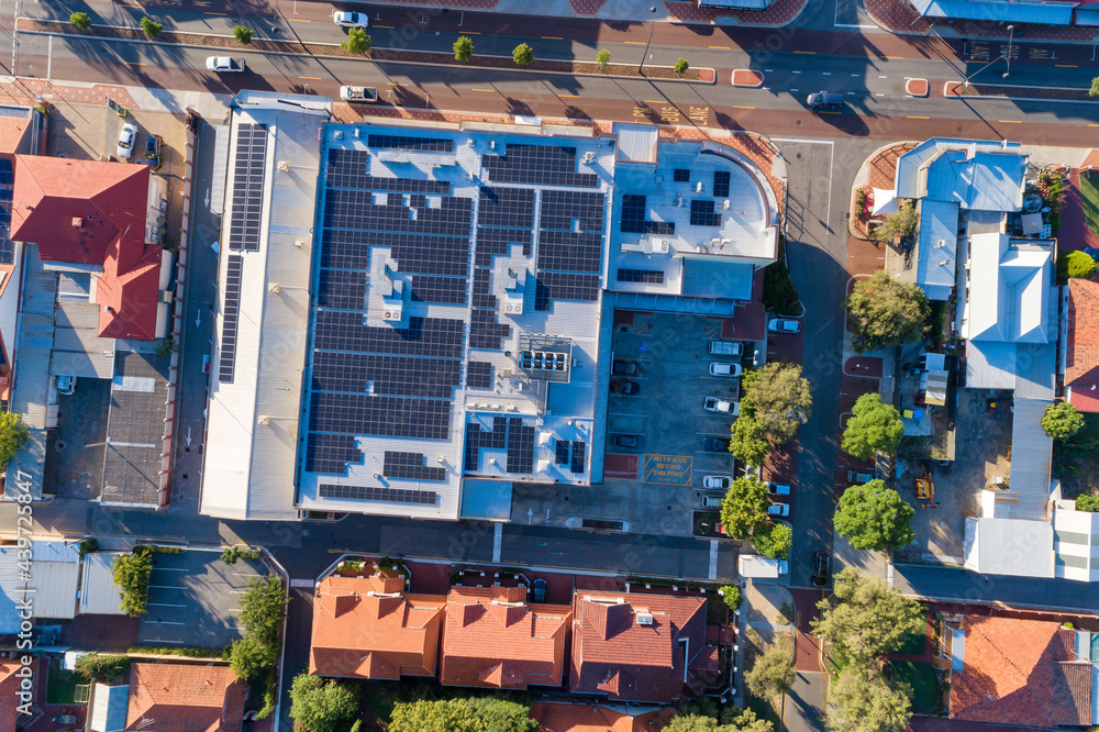 Aerial views over commercial building with over 600 solar panels ...