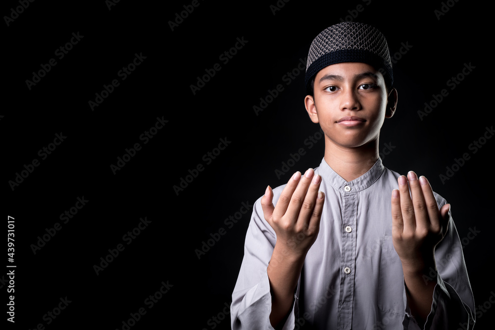 Portrait A Muslim boy in Asian Islam is praying for prayer with faith ...
