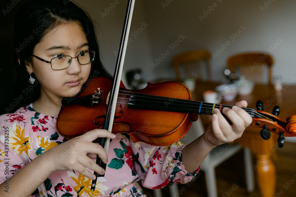 tween girl practicing the violin Stock Photo | Adobe Stock