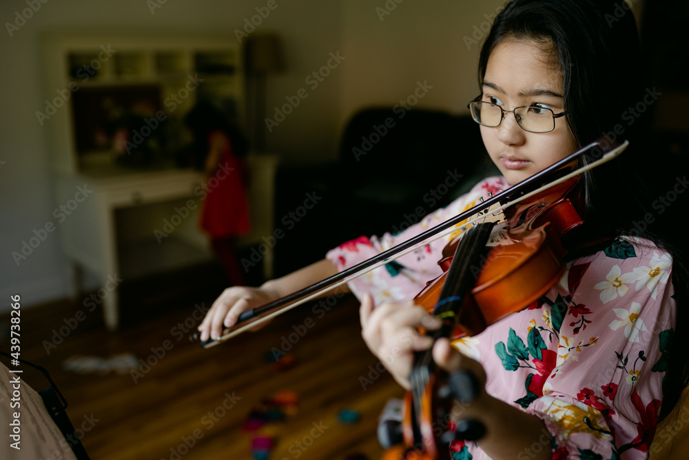 tween girl practicing the violin Stock Photo | Adobe Stock