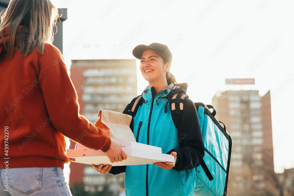 Delivery Girl Delivering Food to Customer Stock Photo | Adobe Stock